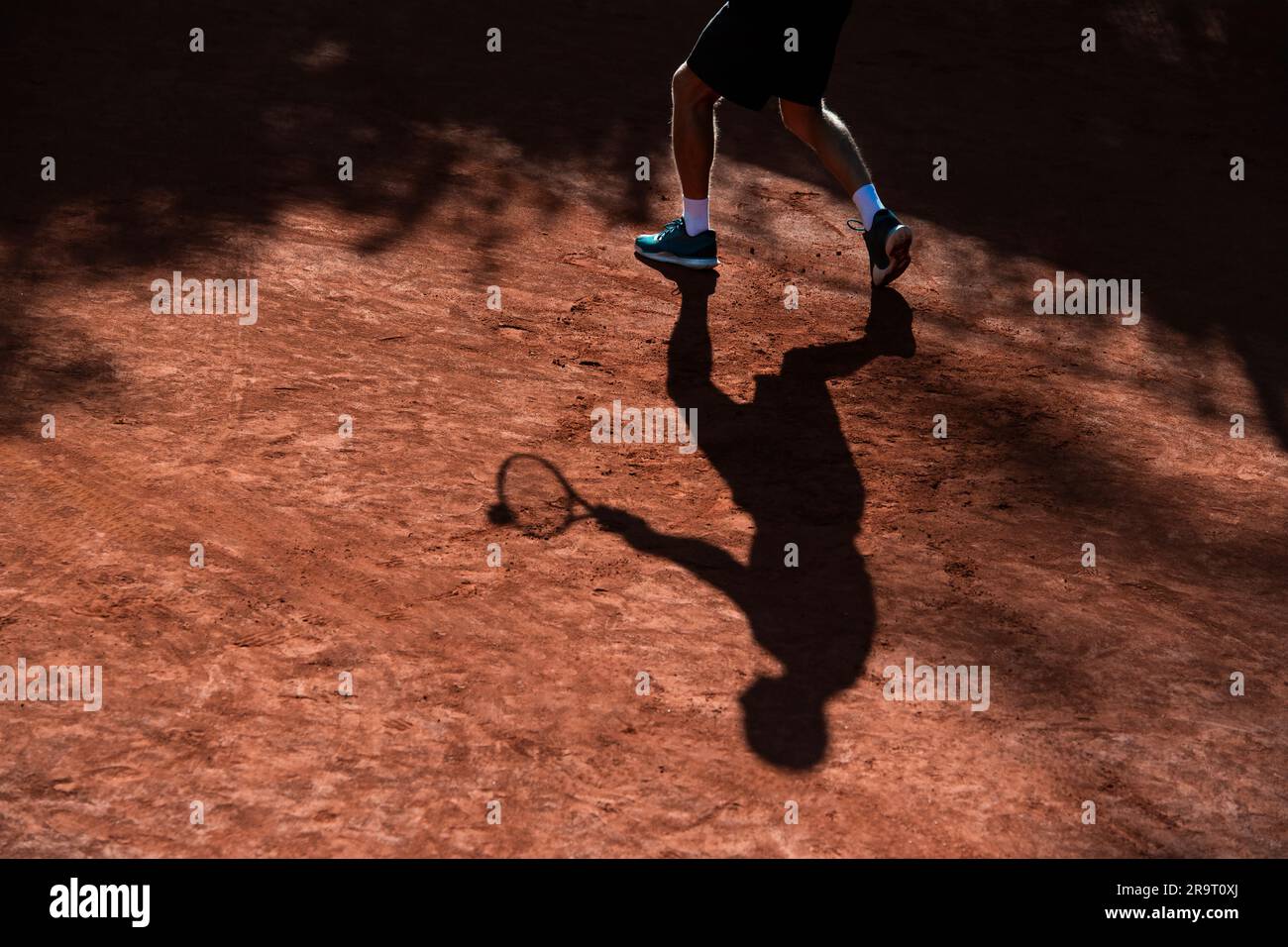 Tennis player shadow on a clay tennis court. Horizontal sport theme ...