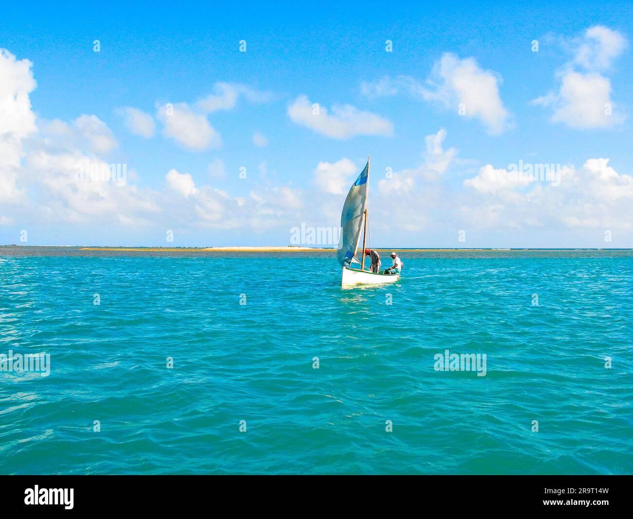 A sailing boat with fishermen returning from the sea, blue ocean, blue ...