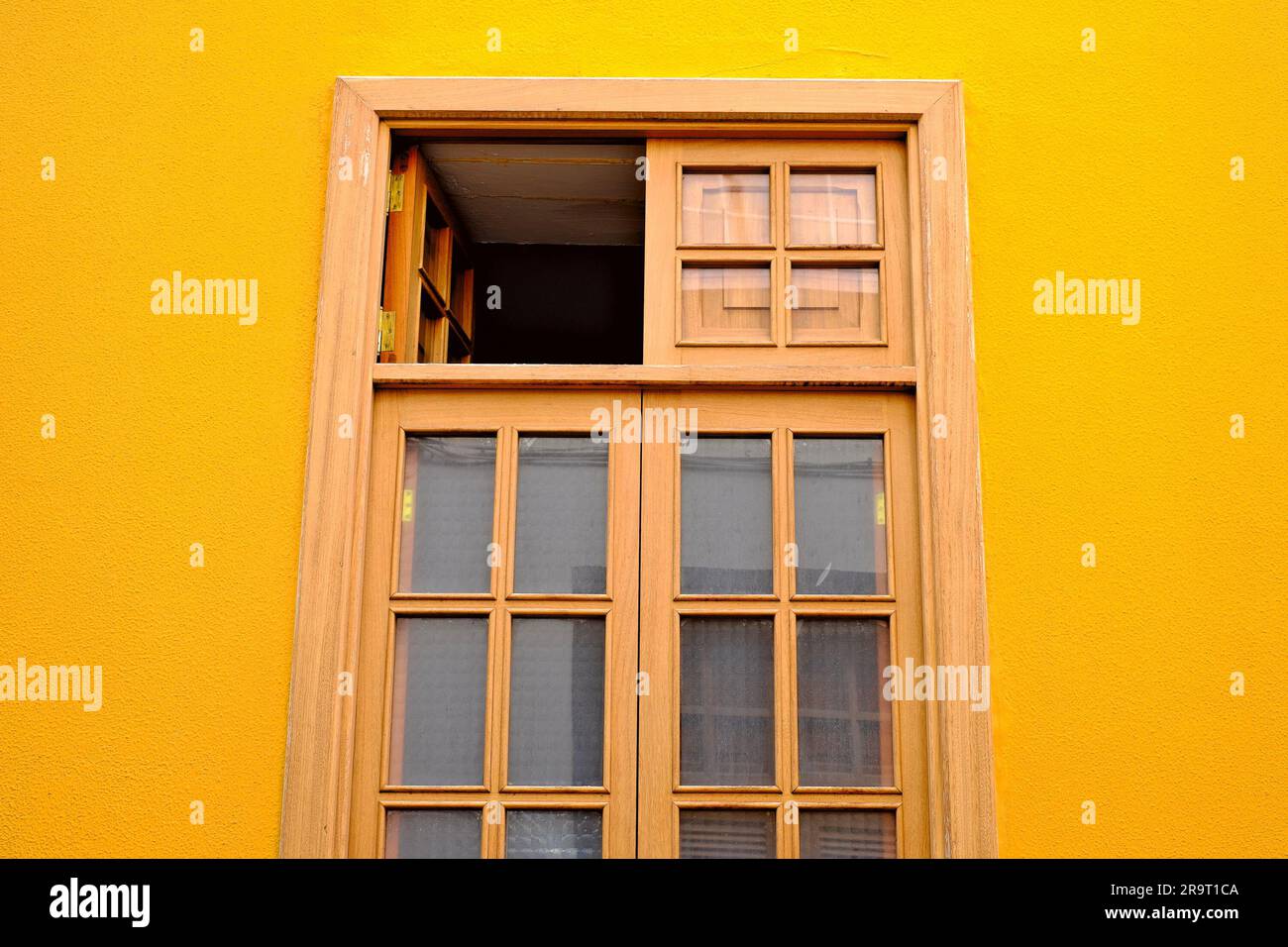 Open window in vivid orange wall Stock Photo - Alamy