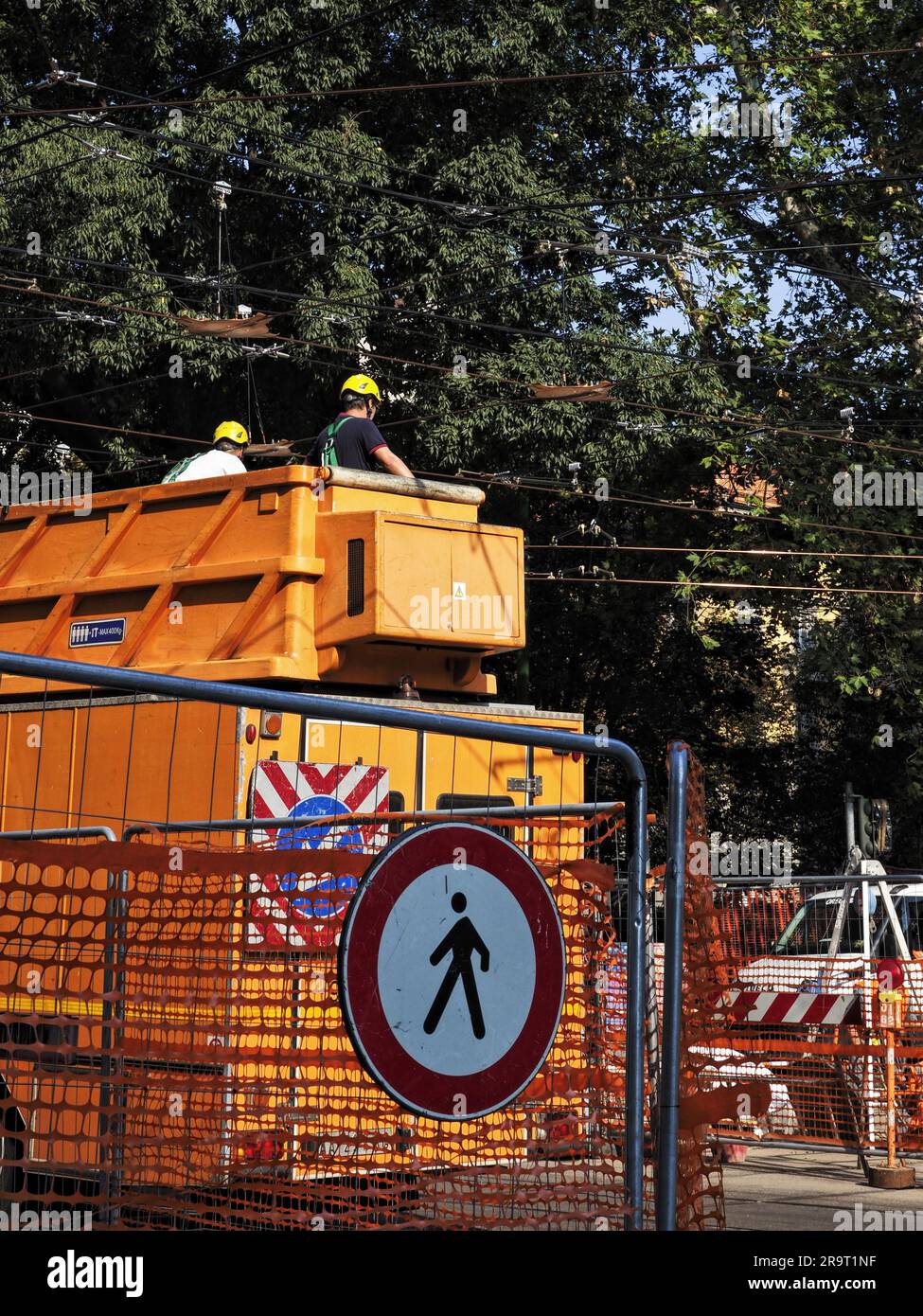 An orange barricade has been installed in an area with construction ...