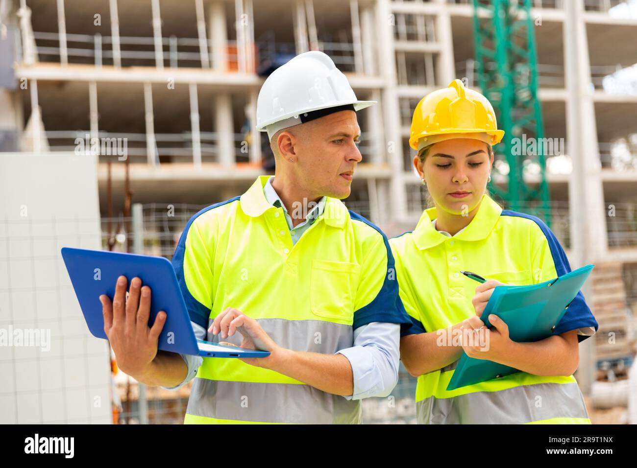 Man and woman engineers in construction site Stock Photo - Alamy