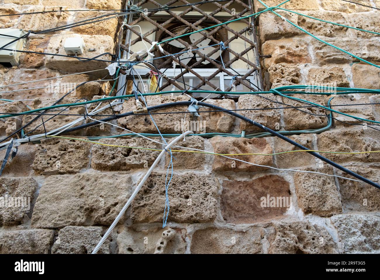 Electric cable and water pipe installation on the building exterior ...