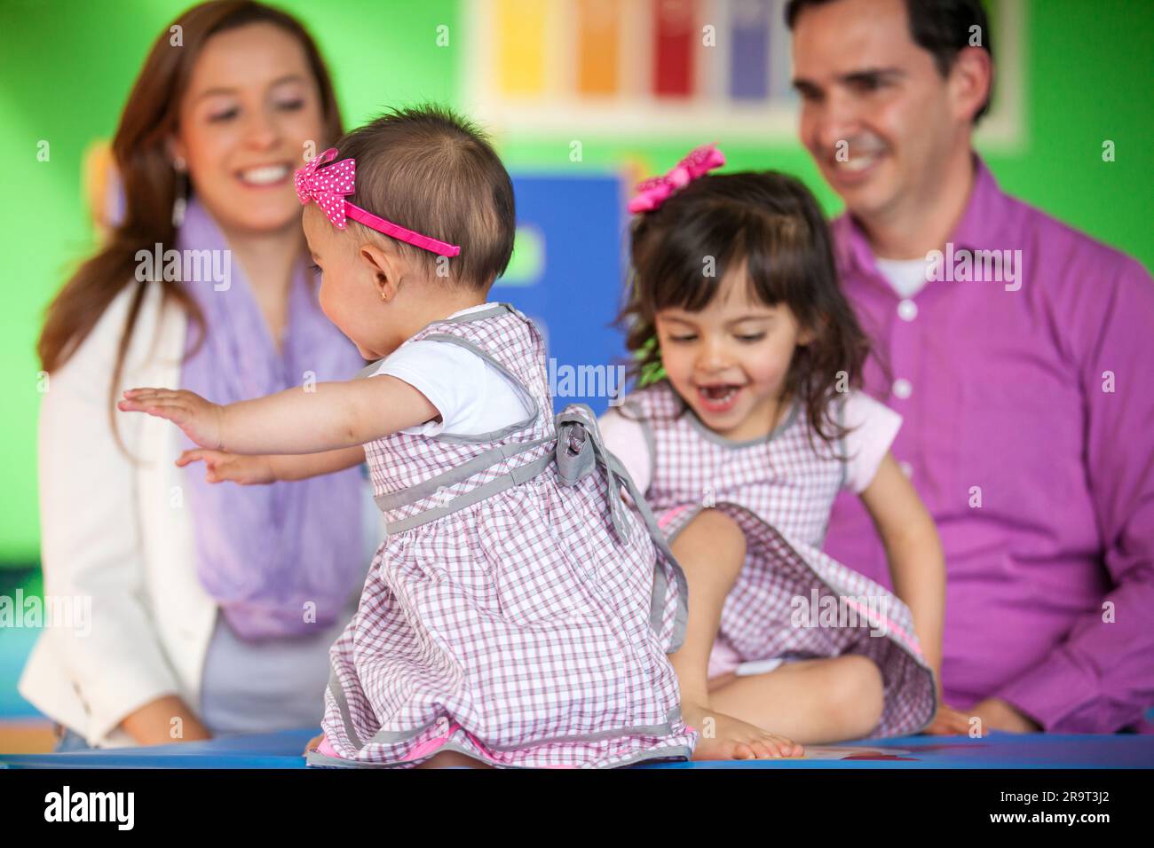 Beautiful ten months baby girl playing with her sister and their ...