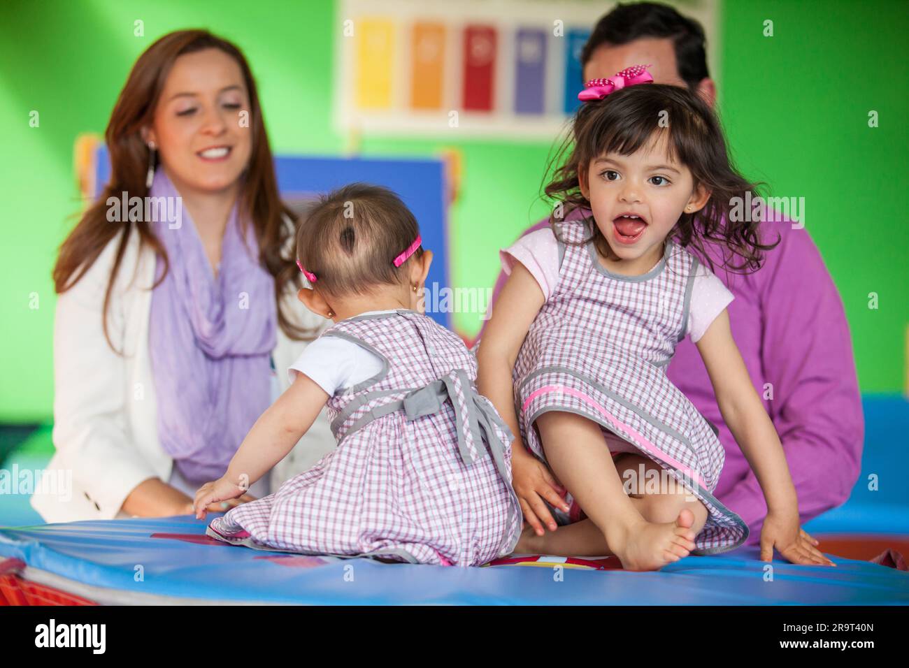 Beautiful small girl playing with her ten months baby girl sister and ...