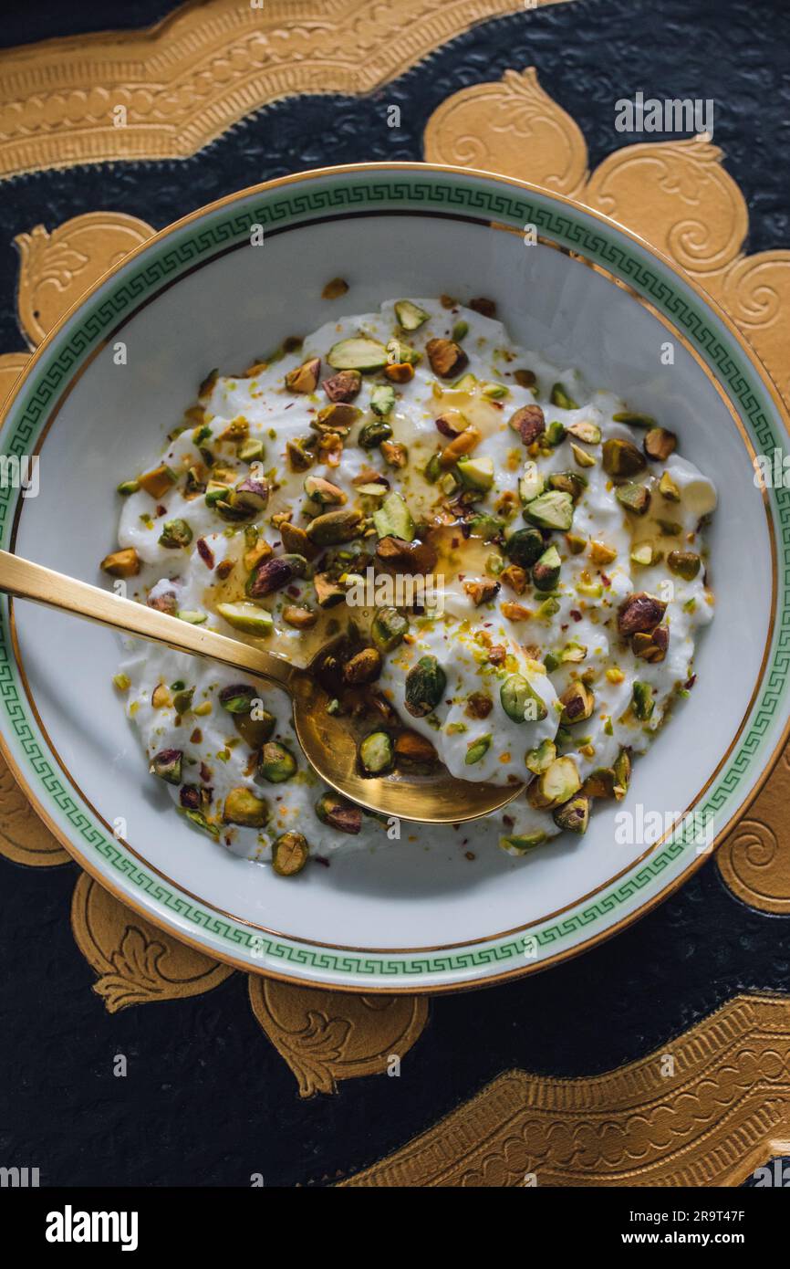 greek yogurt with green pistachios and honey drizzle in white, green ...