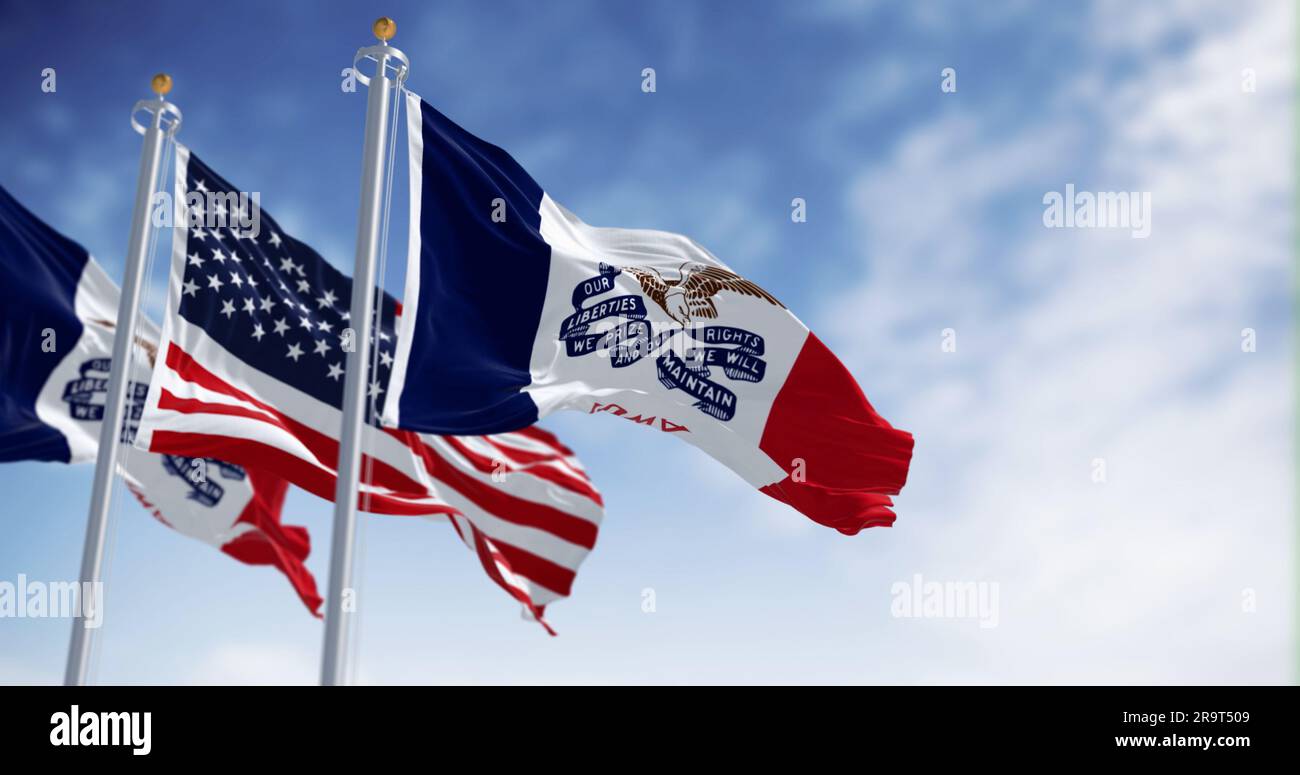 Flags of Iowa and the United States waving in the wind on a clear day ...
