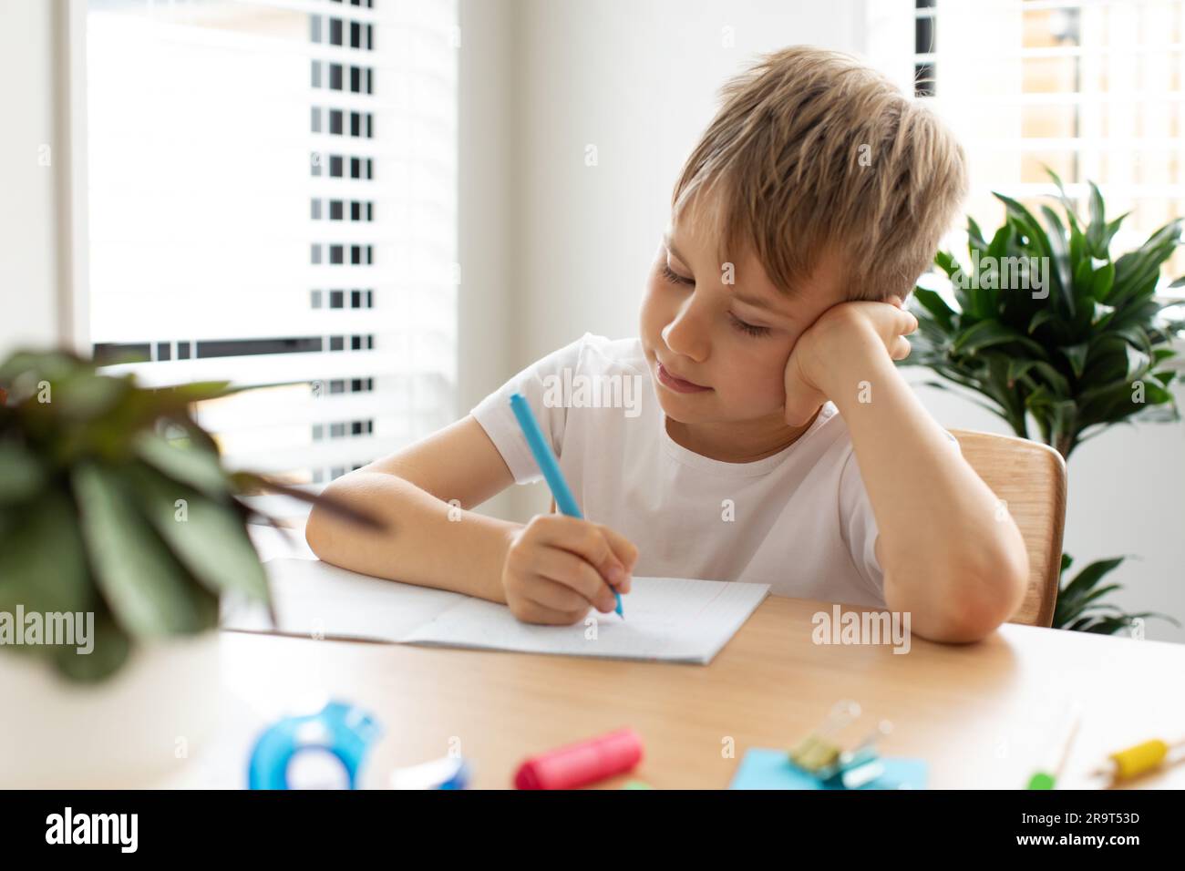 Cute boy doing school homework at home. Distance education. Online ...