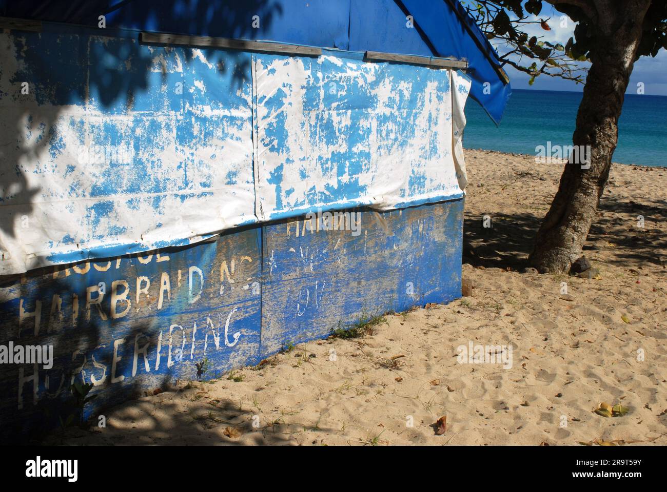 Hand written advertising painted on side of blue hut, Hair braiding and ...