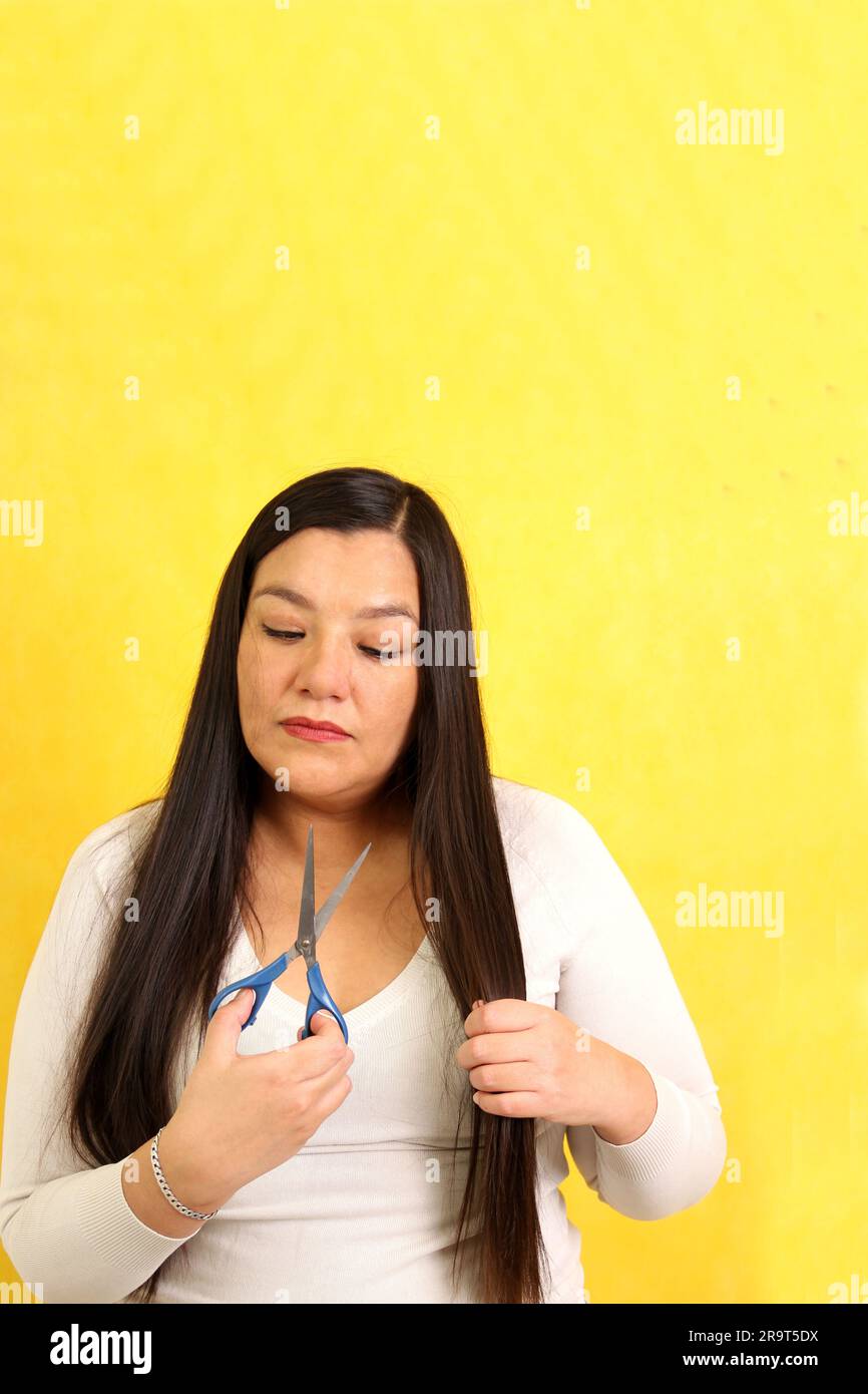 40 Year Old Latina Woman With Very Long Straight Hair Wants To Cut Her Hair With Scissors Stock
