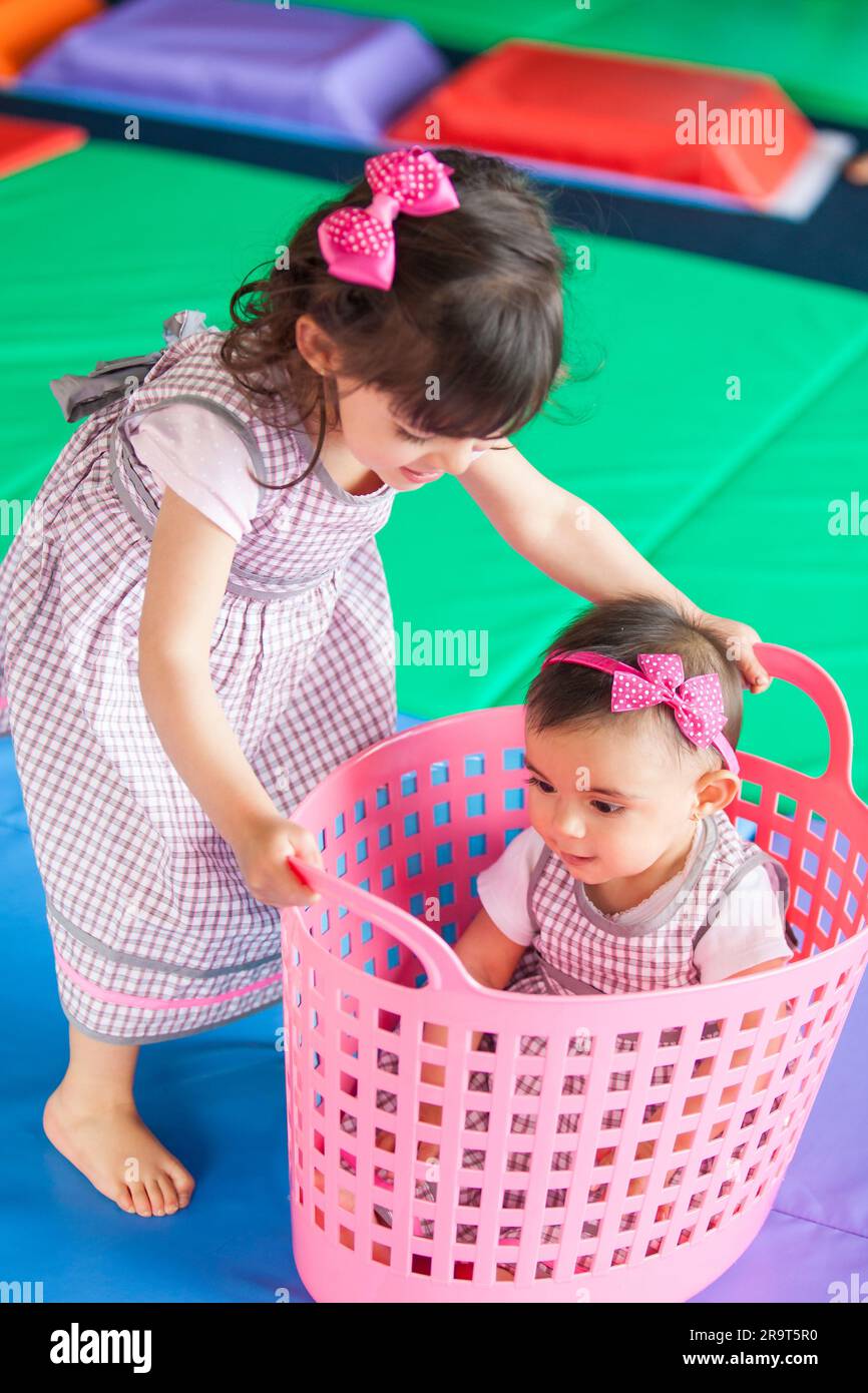Beautiful ten months baby girl playing with her sister. Early ...