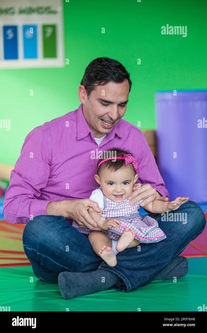 Beautiful ten months baby girl playing with her dad. Early stimulation ...