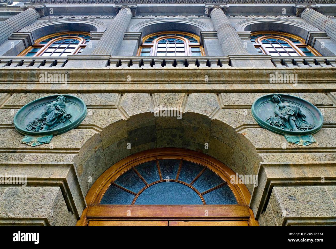 Entrance to an elegant old building, detail of a decorative facade ...