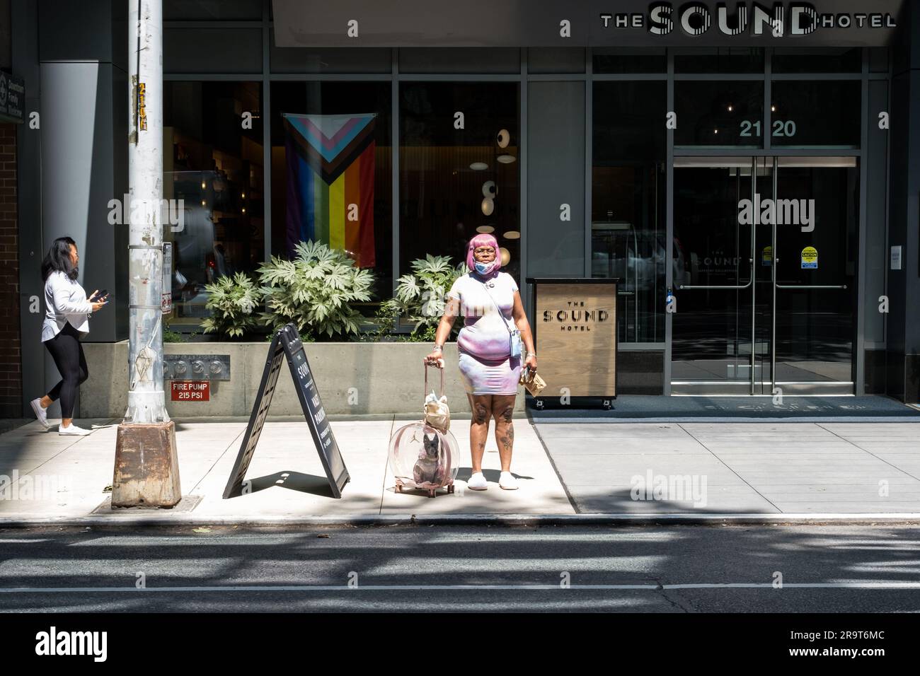 Seattle, USA. 12 Jun, 2023. A sylish person with a small dog and ...