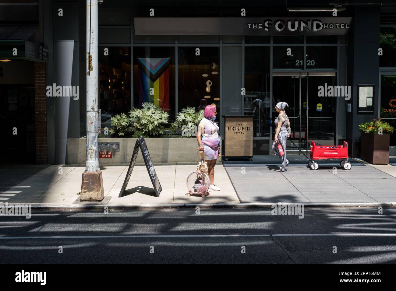 Seattle, USA. 12 Jun, 2023. A sylish person with a small dog and ...