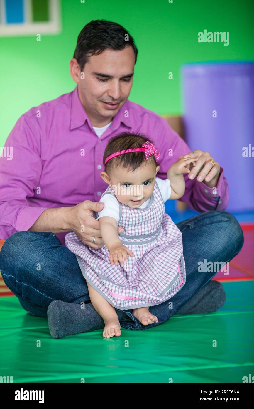 Beautiful ten months baby girl playing with her dad. Early stimulation ...