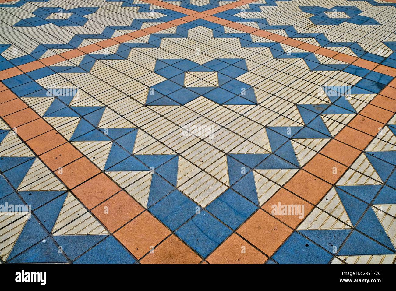 Typical colorful graphic tile work on the pavement in a Spanish town ...