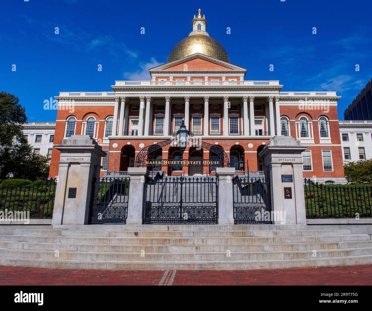 The golden dome or cupola of the Capitol Building, with its red brick ...