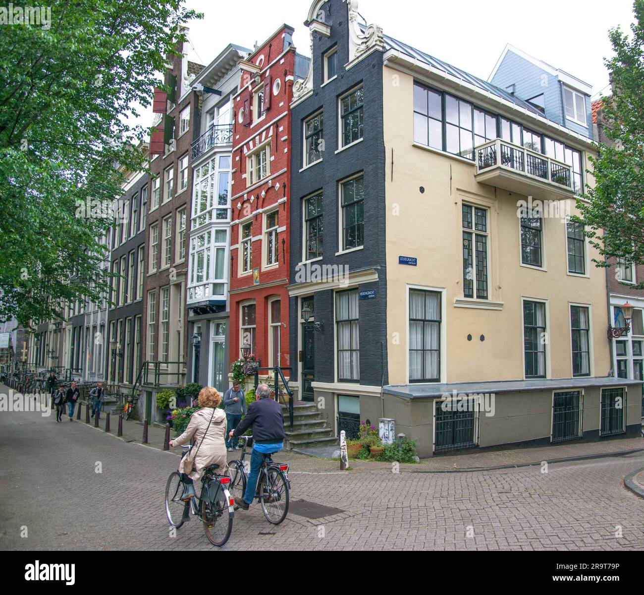 dutch life with people commuting by bicycle in the city of Amsterdam ...