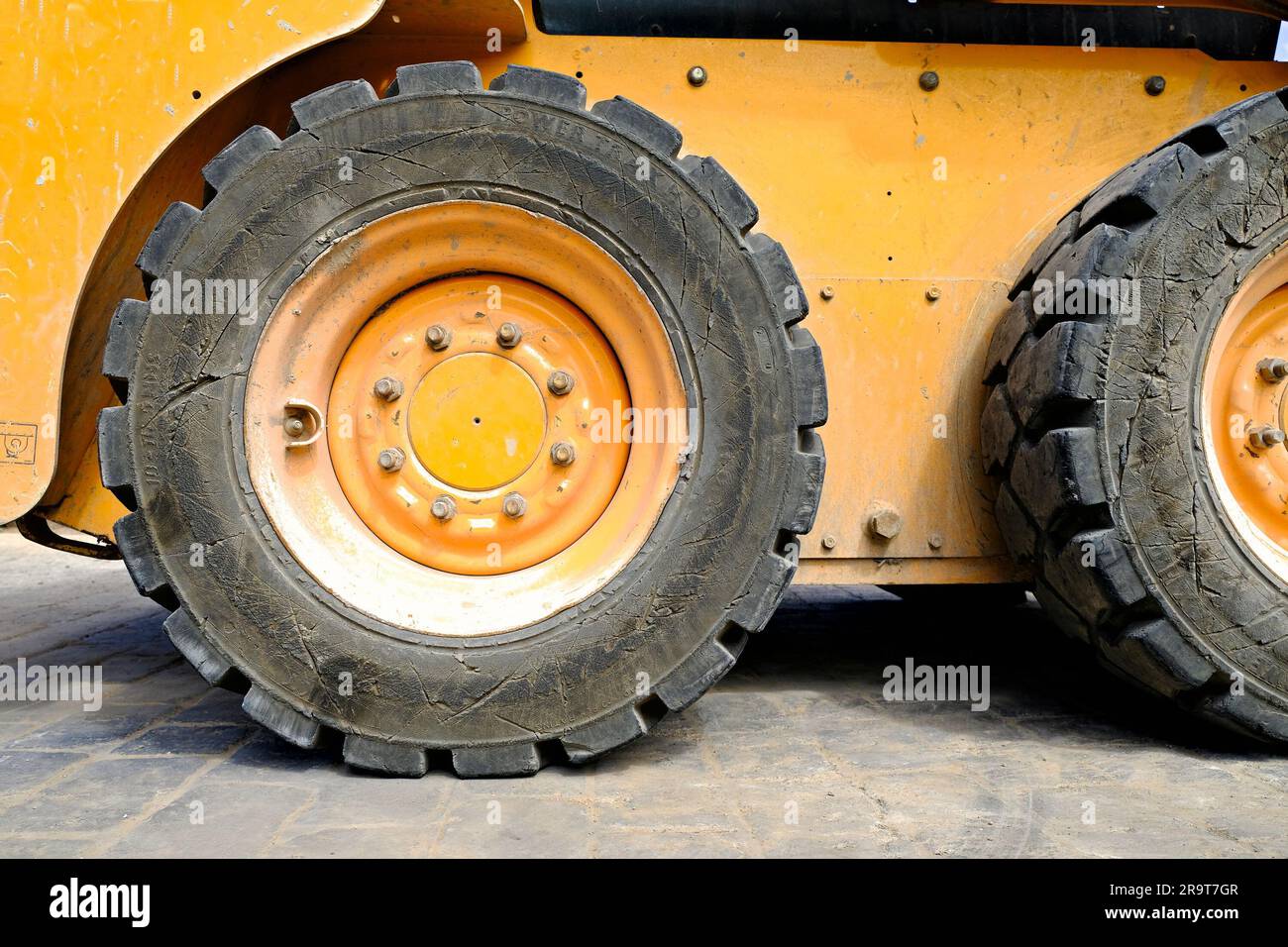 A rear tyre, heavy duty construction site diesel excavator Stock Photo ...