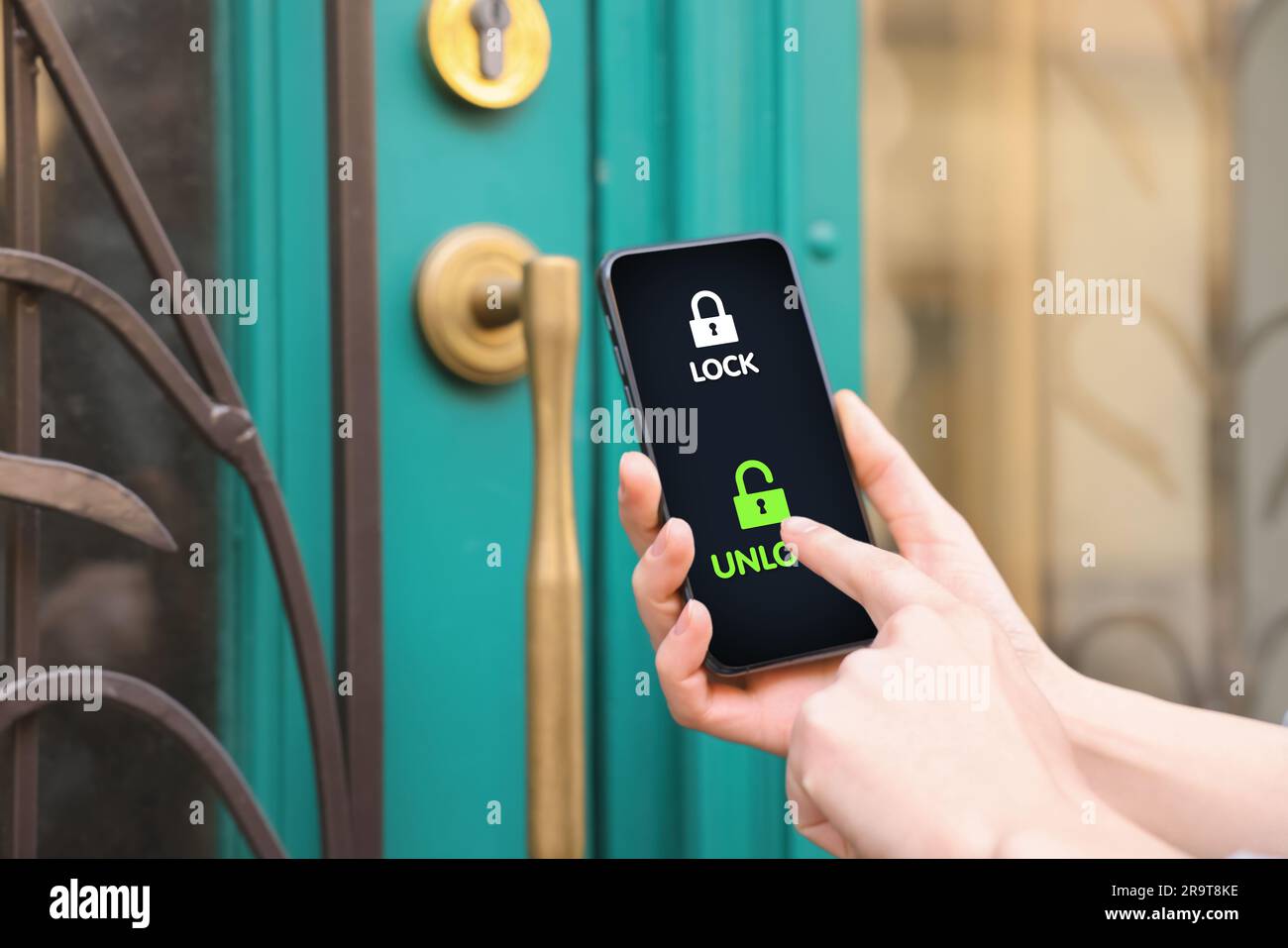Woman unlocking door using mobile phone, closeup. Illustration of ...