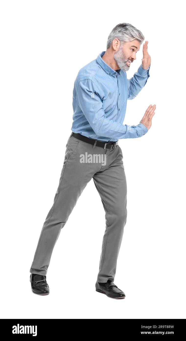 Mature businessman in stylish clothes avoiding something on white ...