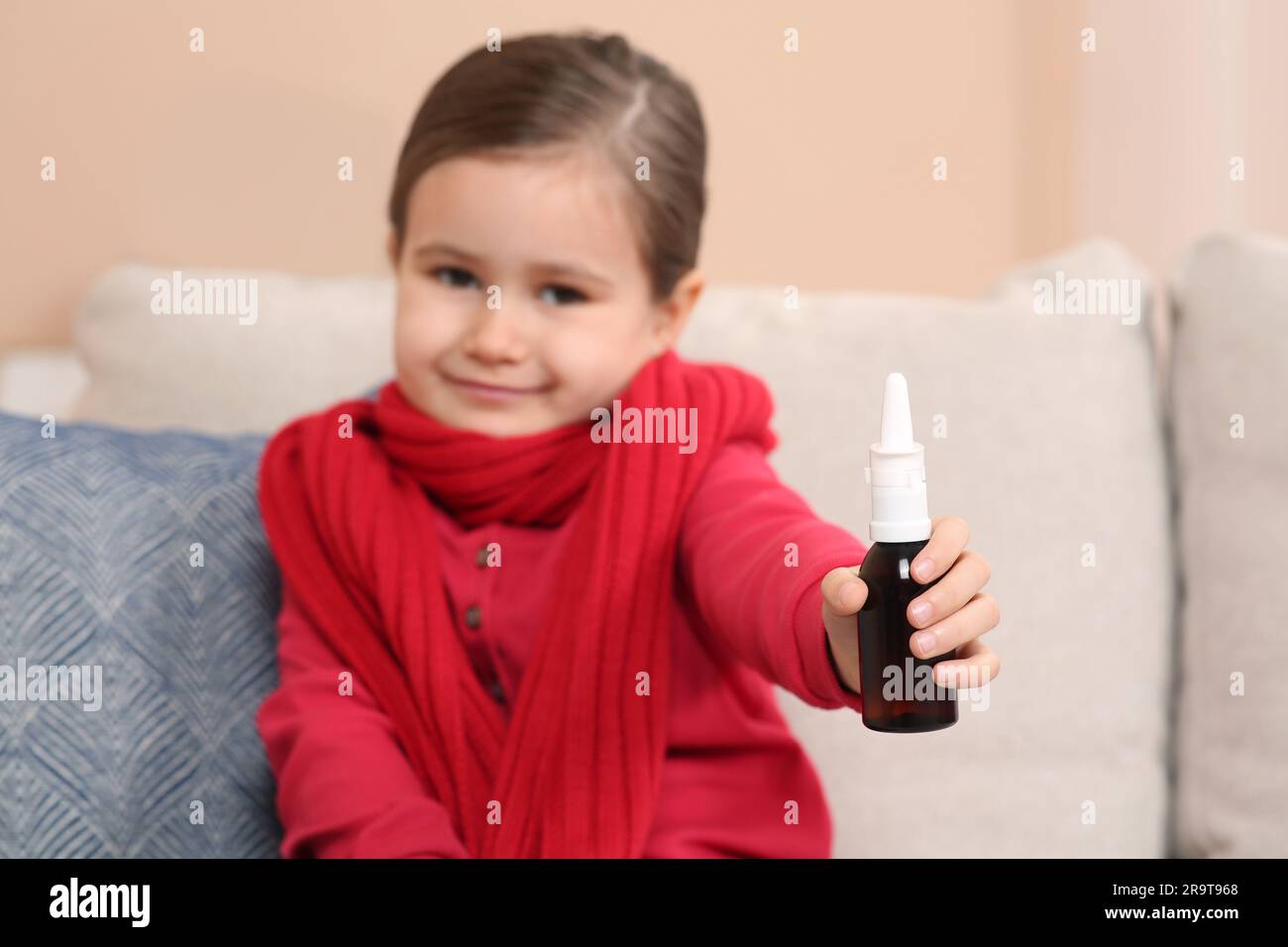 Cute little girl showing nasal spray indoors, focus on hand Stock Photo ...