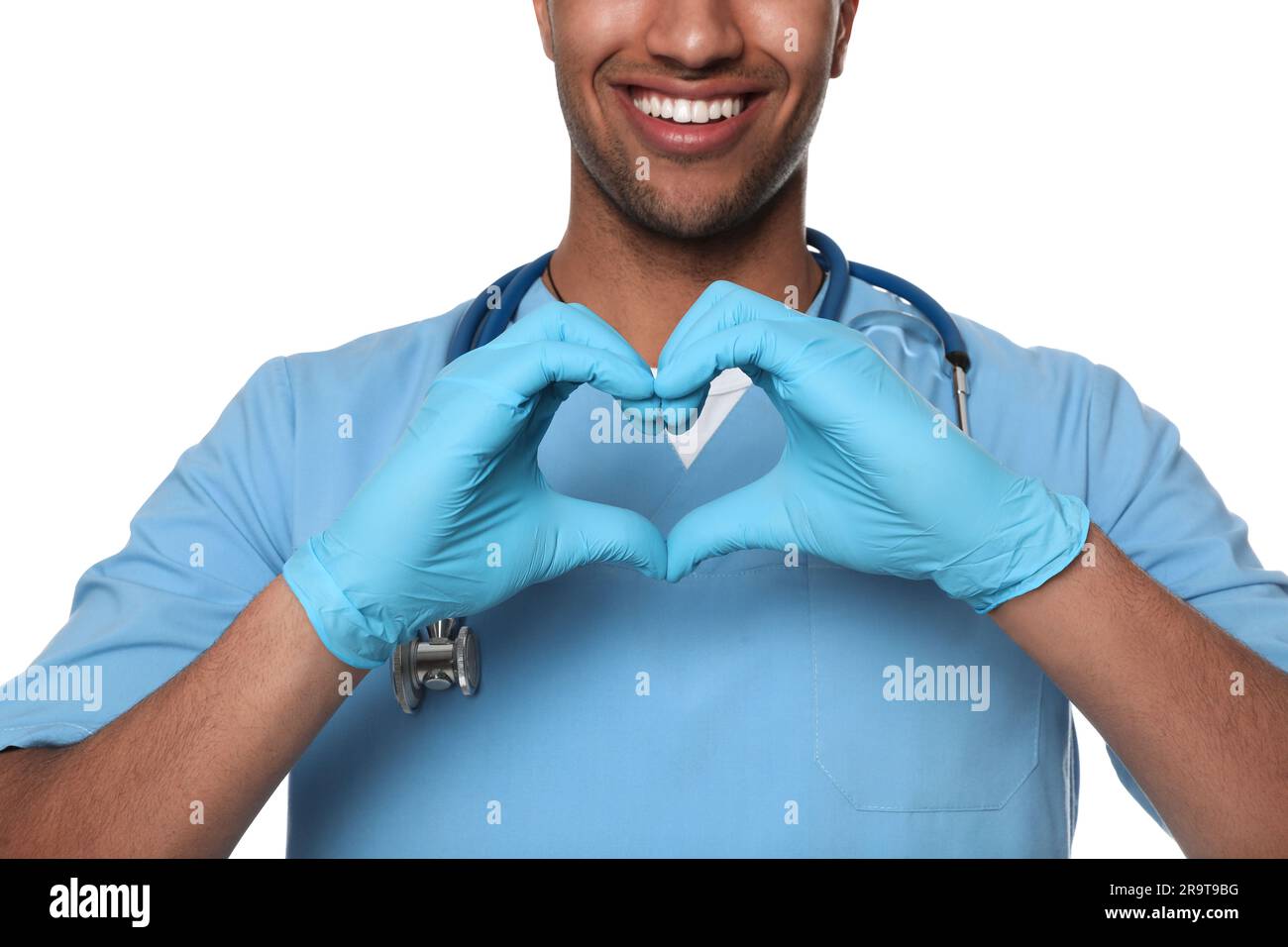 Doctor or medical assistant (male nurse) in uniform making heart shape ...