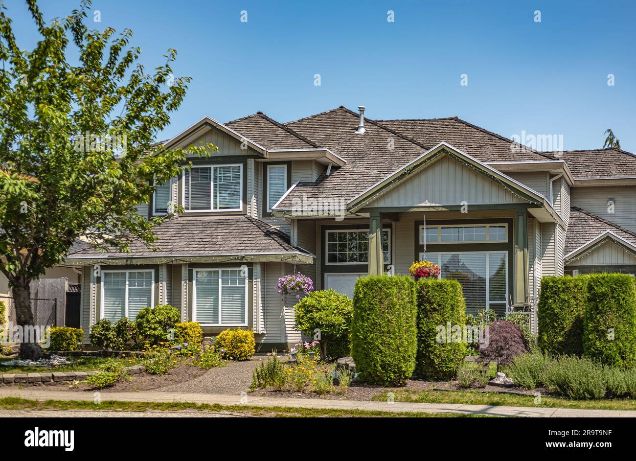 Real Estate Exterior Front House on a sunny day. Big custom made luxury ...