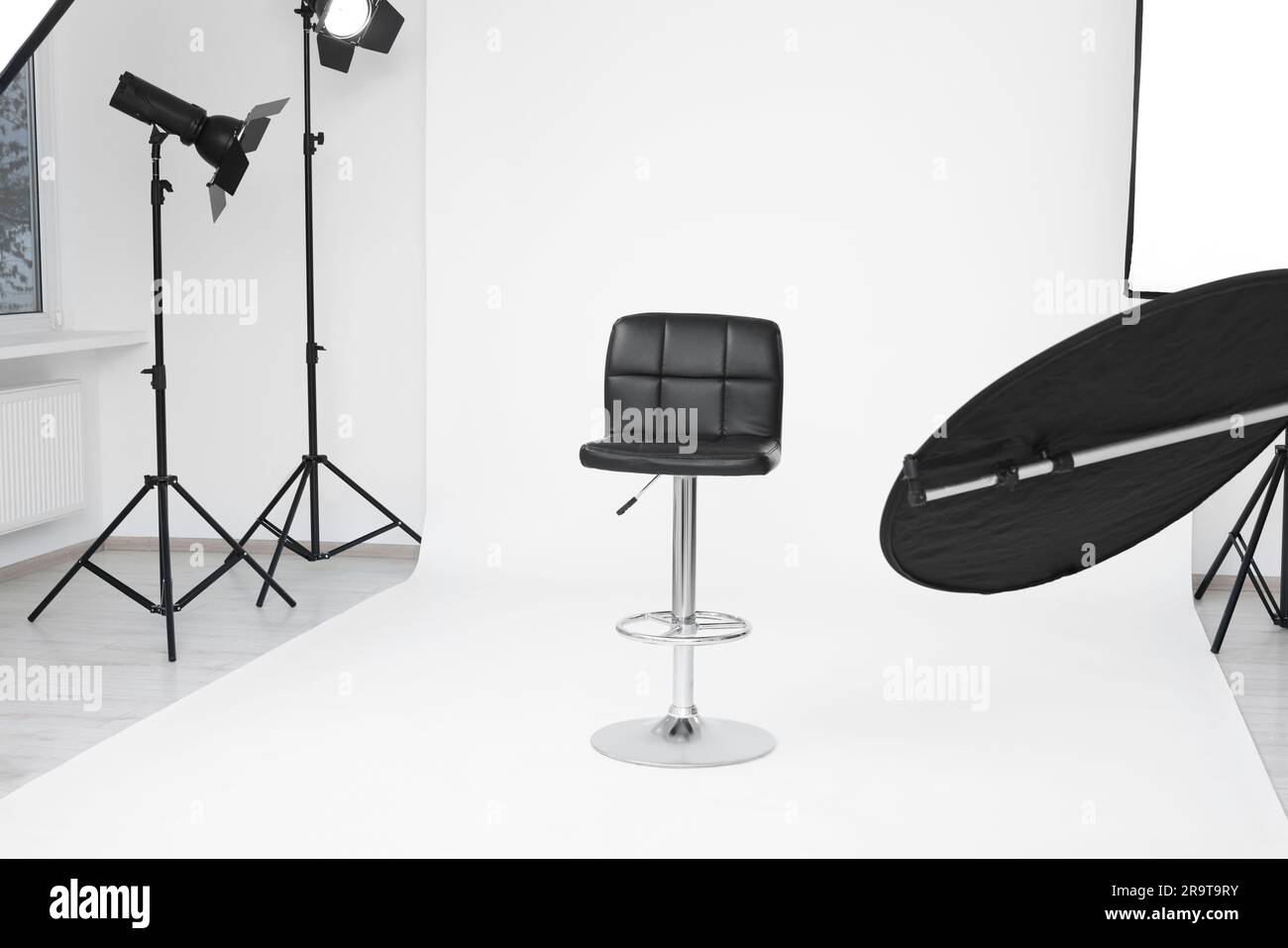 Interior of modern photo studio with bar stool and professional ...