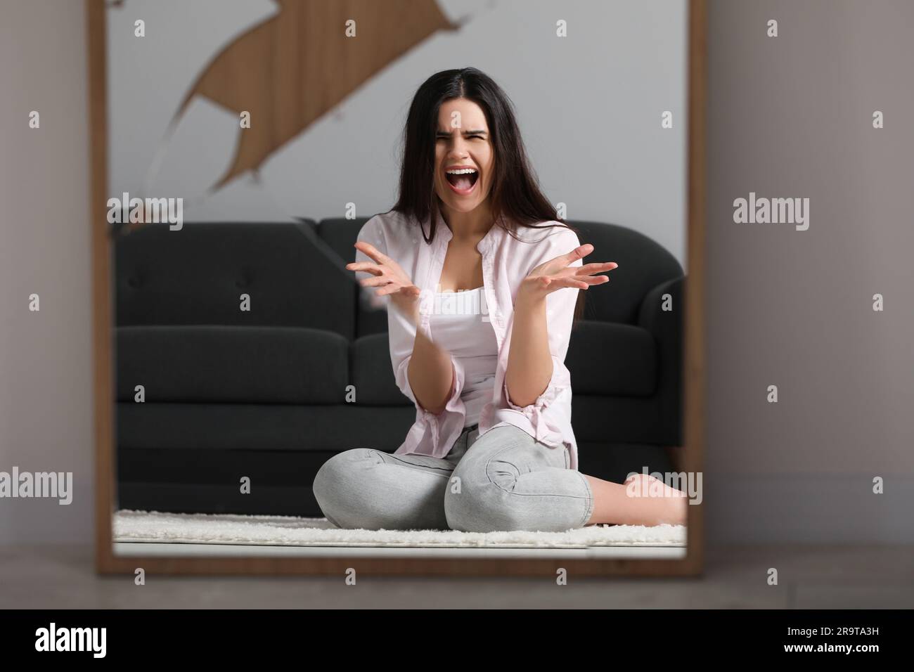 Mental problems. Woman reflecting in broken mirror while screaming at ...