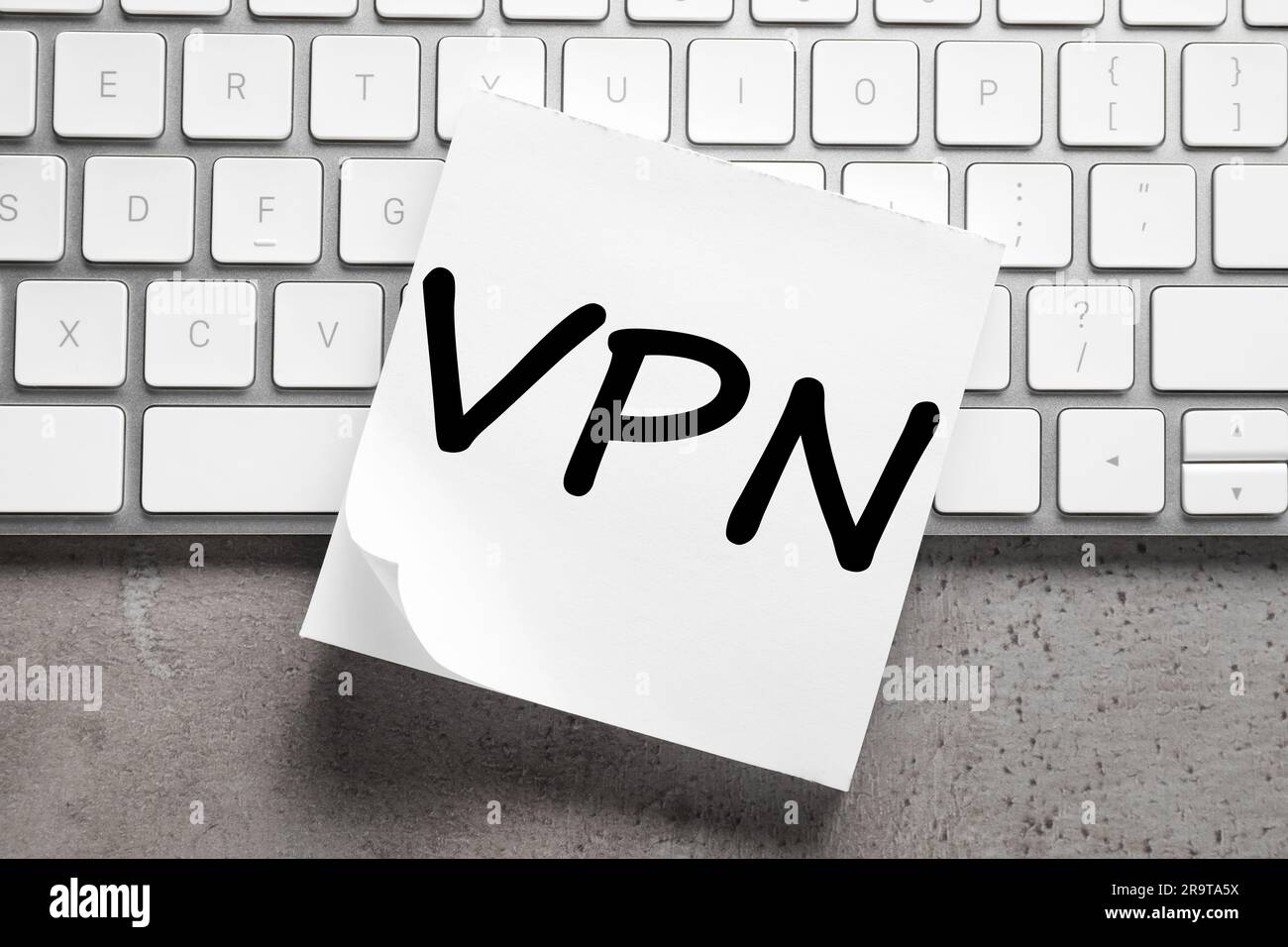 Paper sheet with acronym VPN (Virtual Private Network) and keyboard on ...