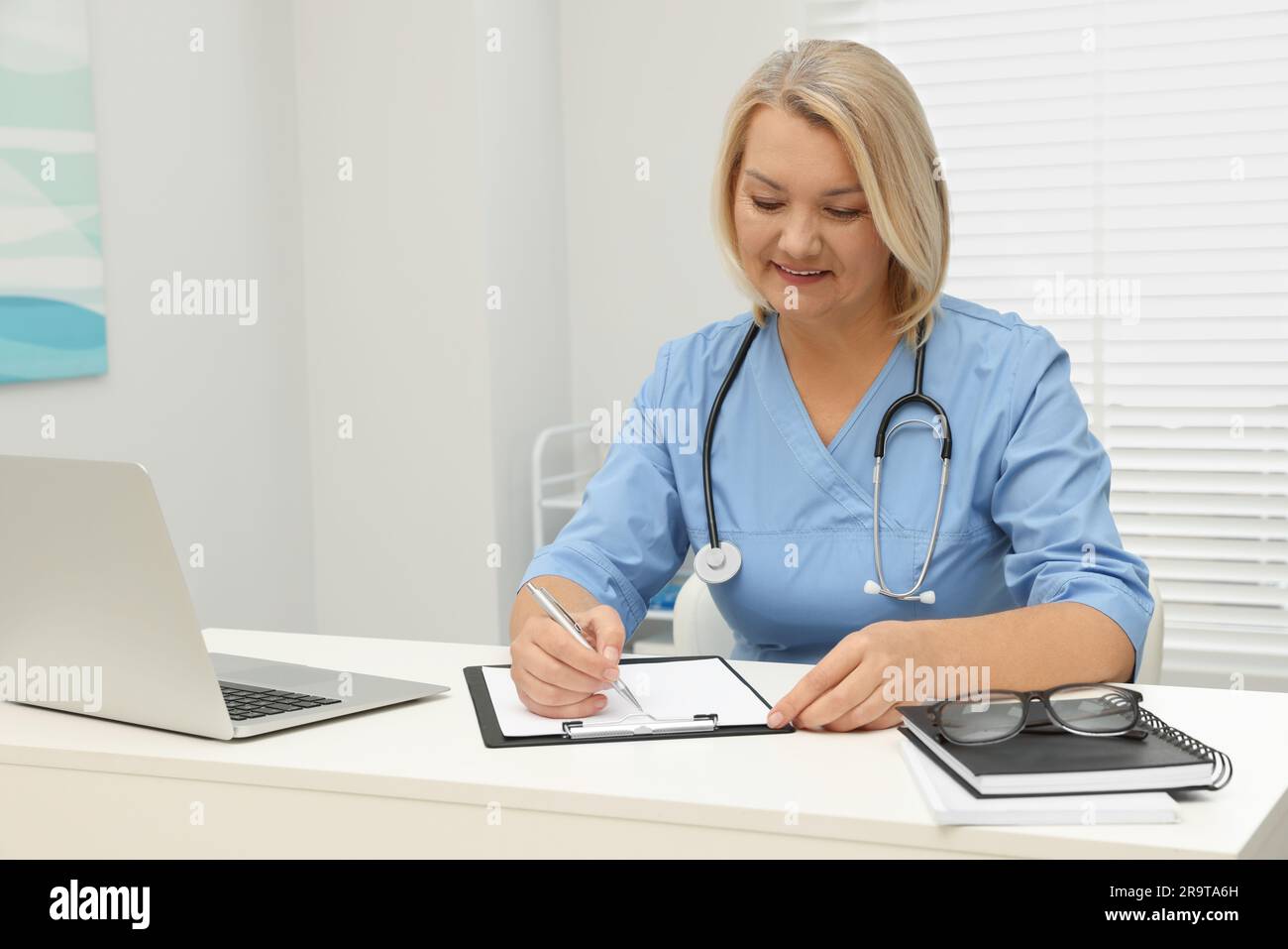 Physician writing information cure in hi-res stock photography and ...