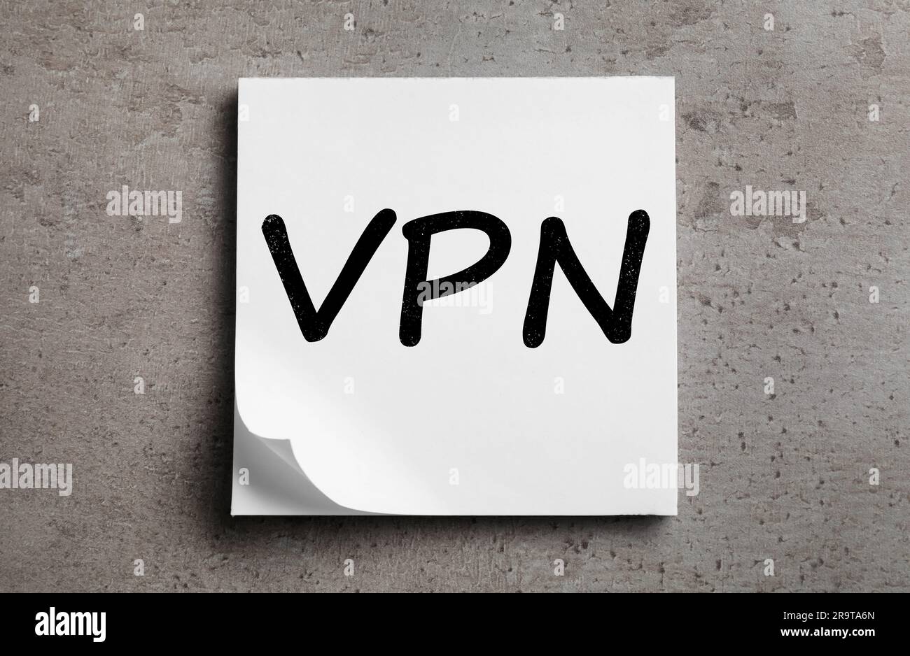 Paper sheet with acronym VPN (Virtual Private Network) on grey table ...