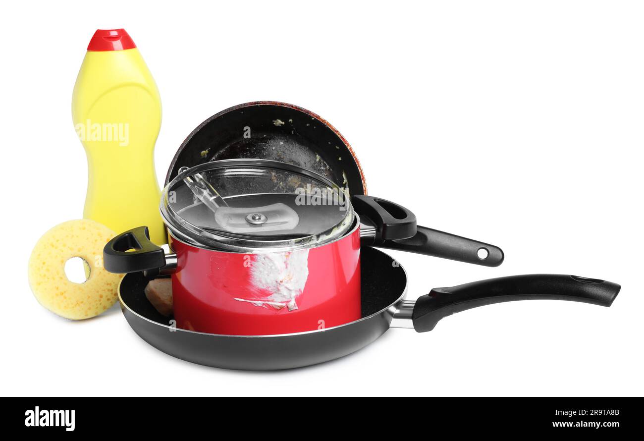 Stack of dirty kitchenware, dish detergent and sponge on white ...