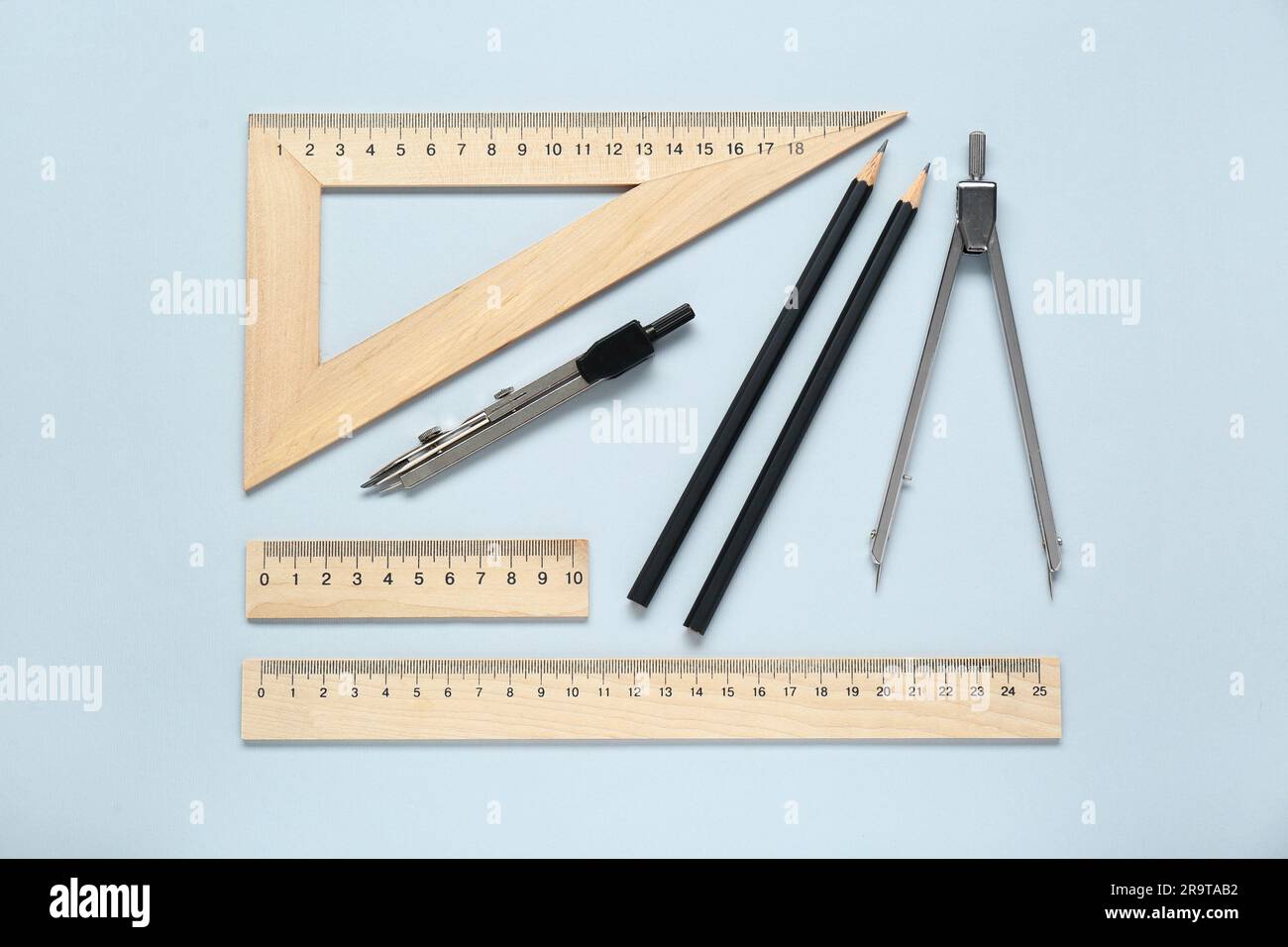 Flat lay composition with rulers and compasses on light grey background ...