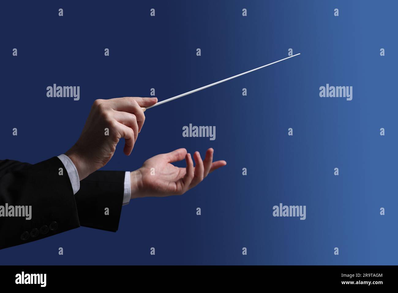 Professional conductor with baton on blue background, closeup Stock ...