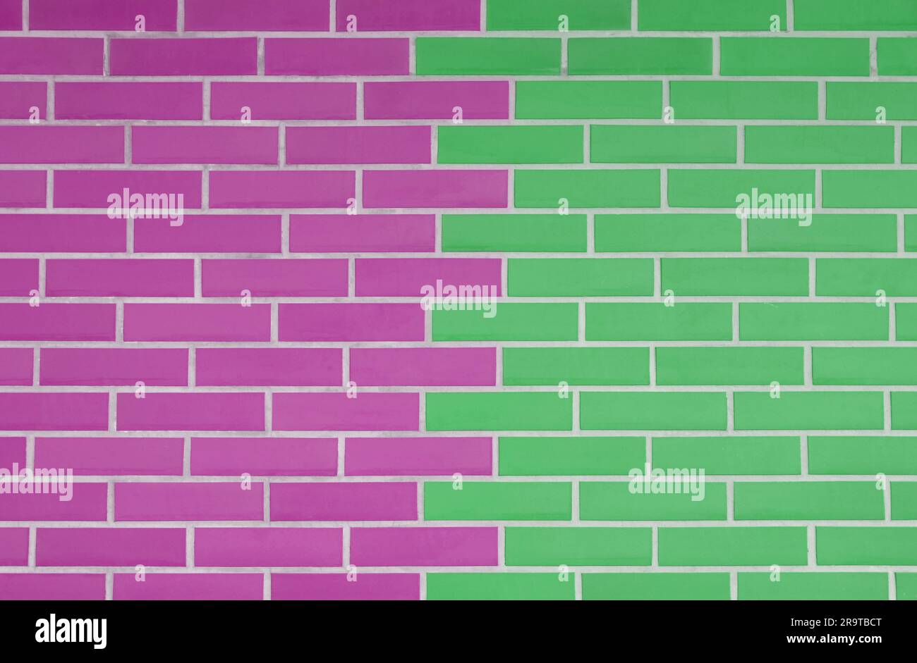Pink and light green brick wall as background Stock Photo - Alamy