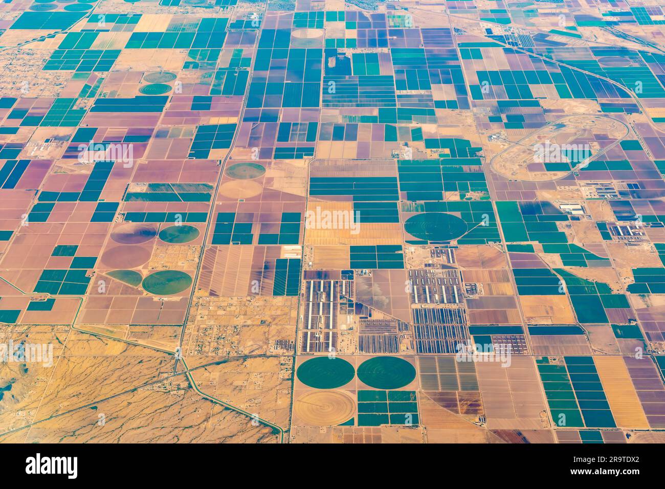 Aerial view of farmland and buildings in the American southwest. Green ...