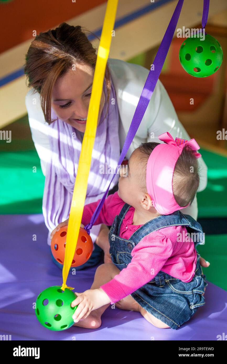 Beautiful ten months baby girl playing with her mom. Early stimulation ...