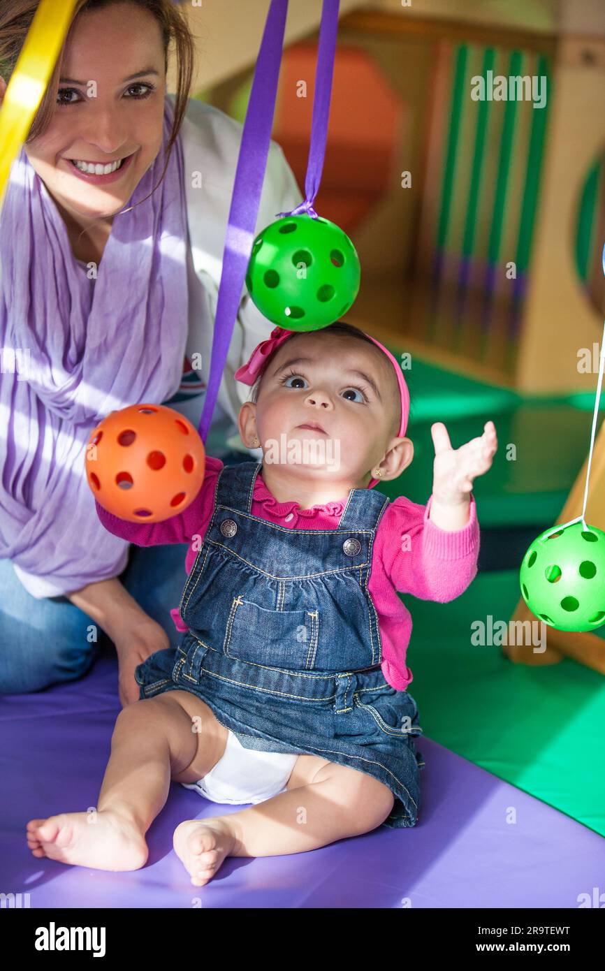 Beautiful ten months baby girl playing with her mom. Early stimulation ...