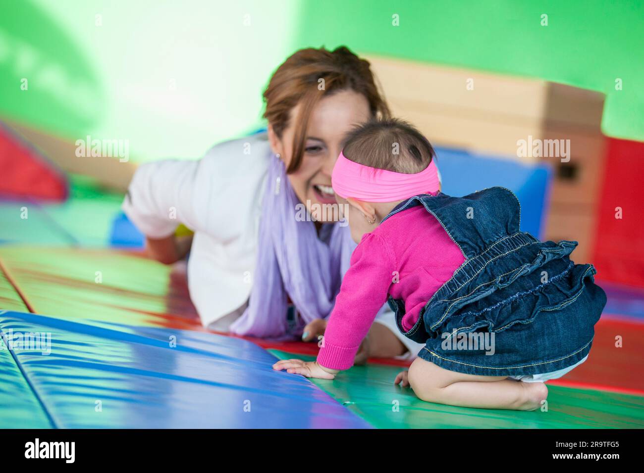 Beautiful ten months baby girl playing with her mom. Early stimulation ...