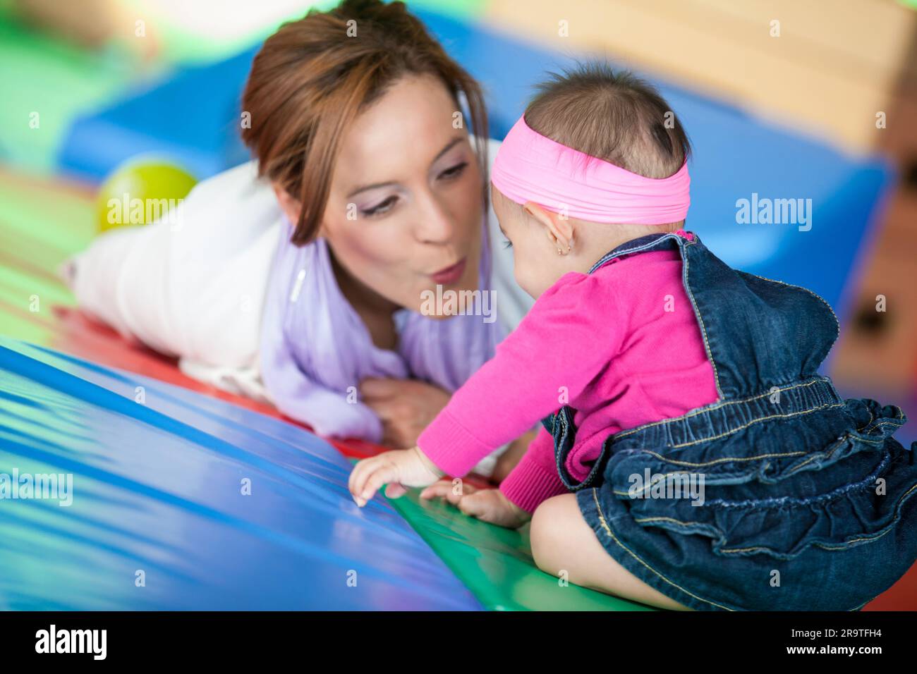 Beautiful ten months baby girl playing with her mom. Early stimulation ...