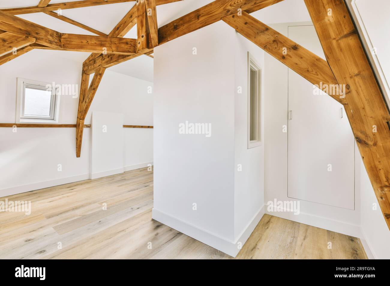 an empty room with wood beams on the ceiling and wooden flooring in ...