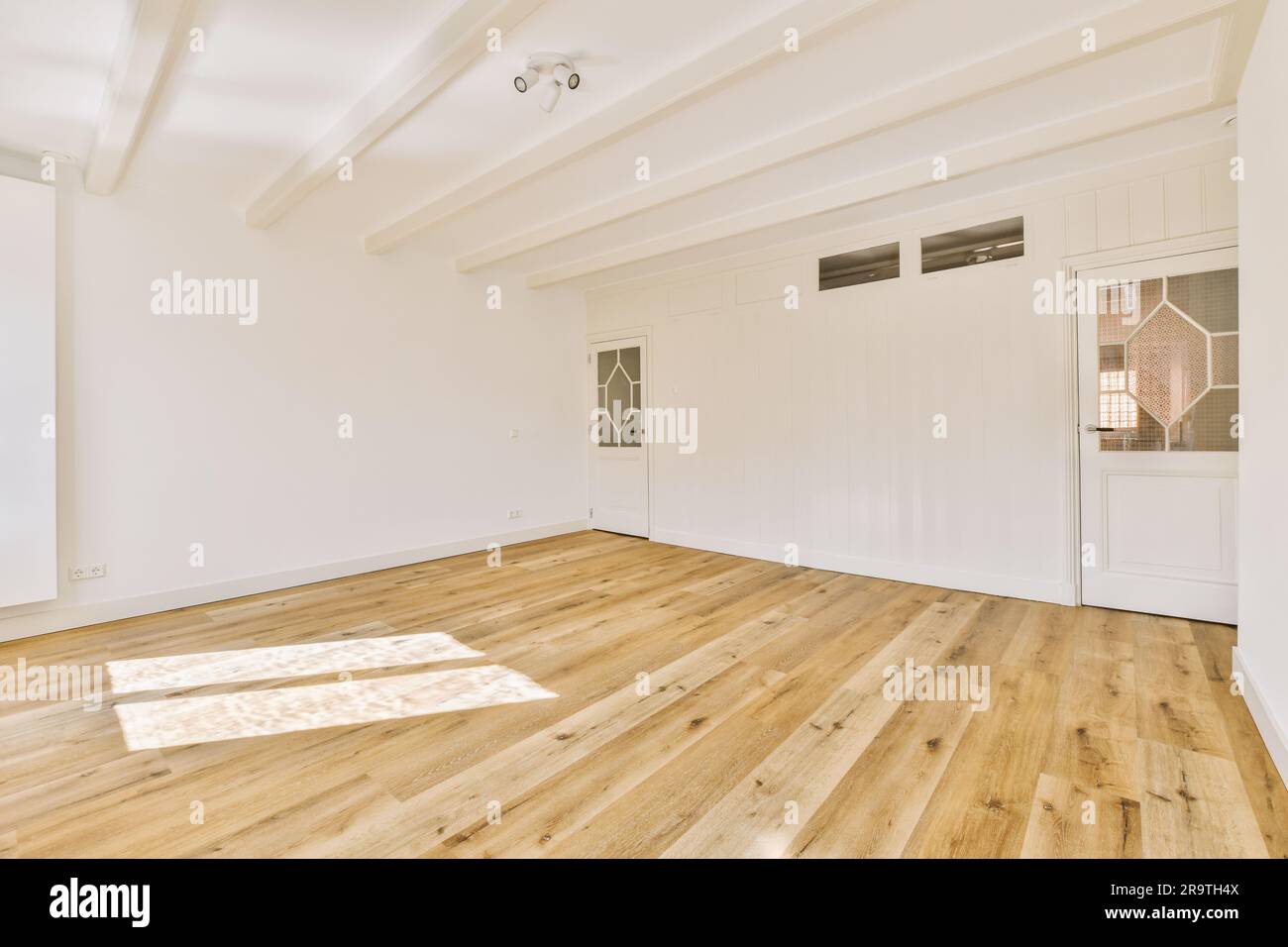 an empty room with wood flooring and white paint on the walls there is ...