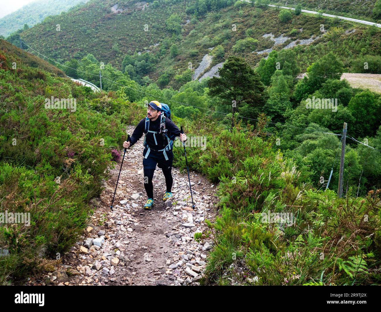 A man is seen going up a tough climb. The Camino de Santiago (the Way ...