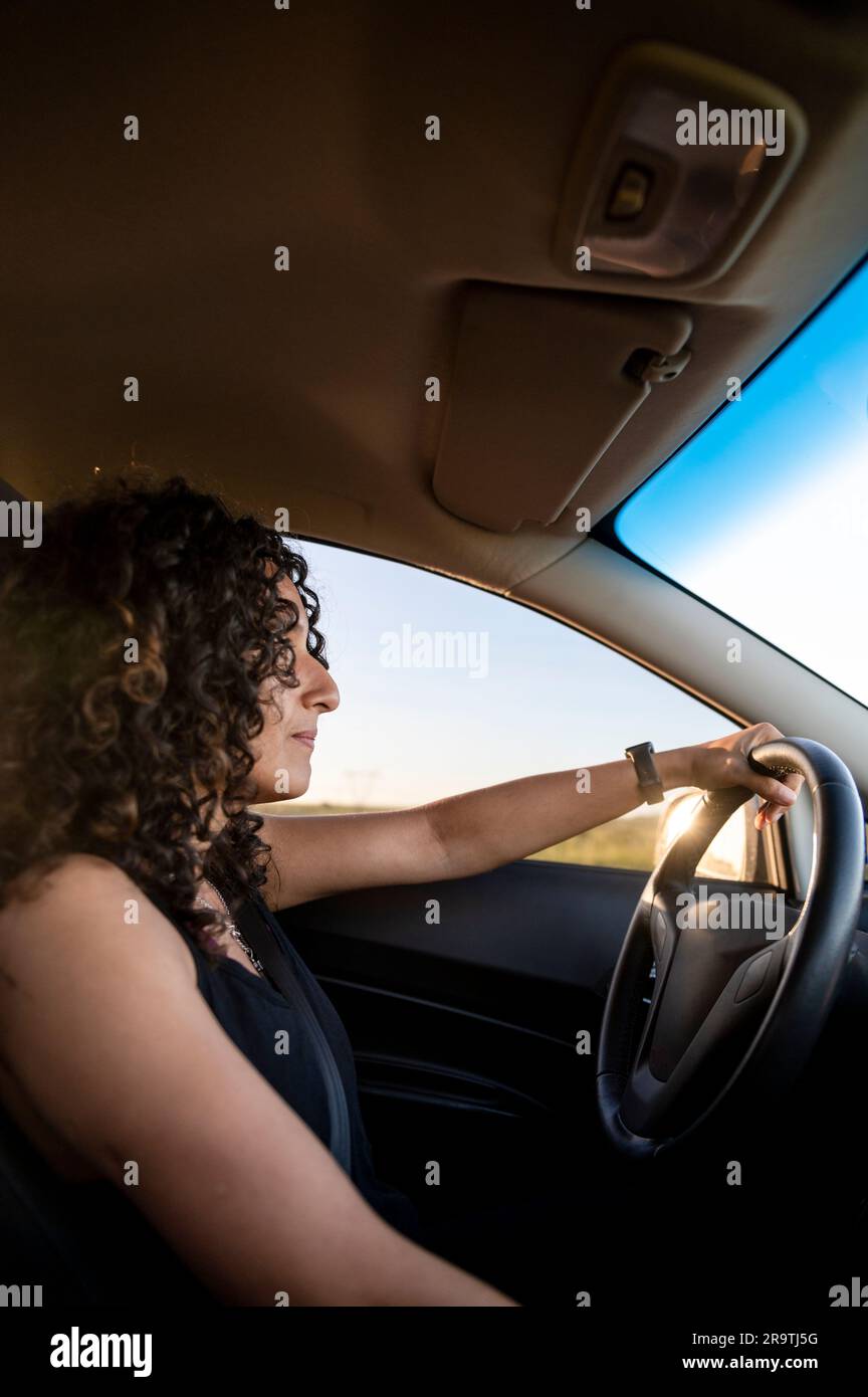 Young serious woman driving a car on the road Stock Photo - Alamy