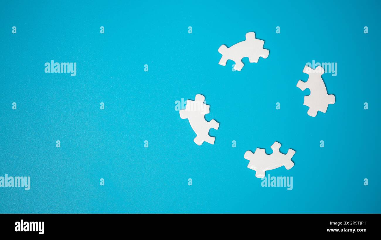White part of jigsaw puzzle pieces on blue background. concepts of ...