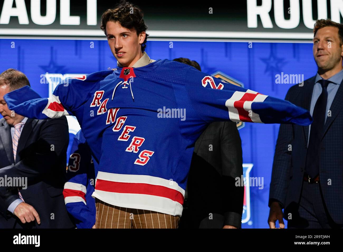 Gabriel Perreault puts on a New York Rangers jersey after being picked ...
