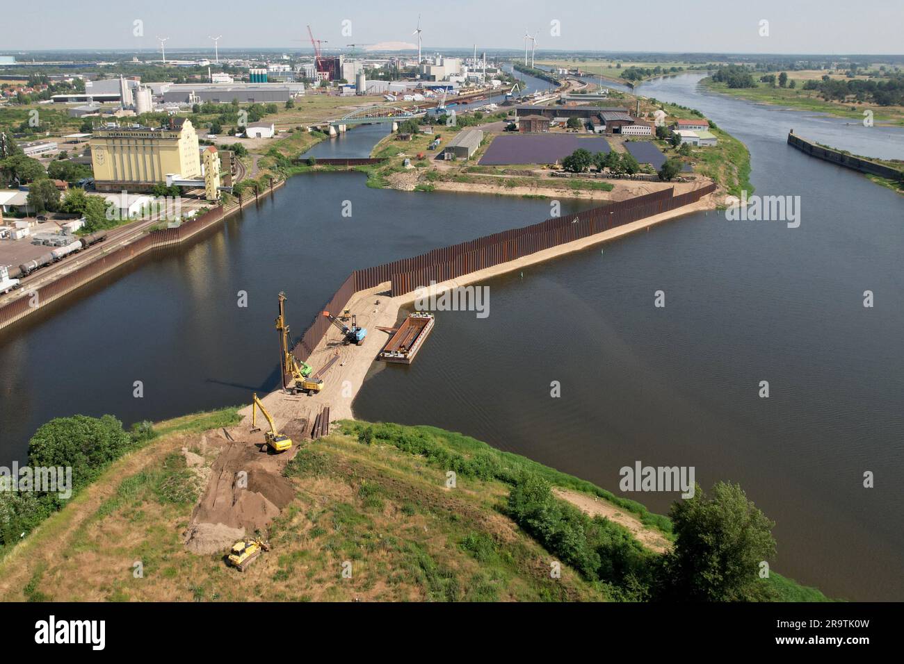 Magdeburg, Germany. 26th June, 2023. Excavators and barges work on the ...