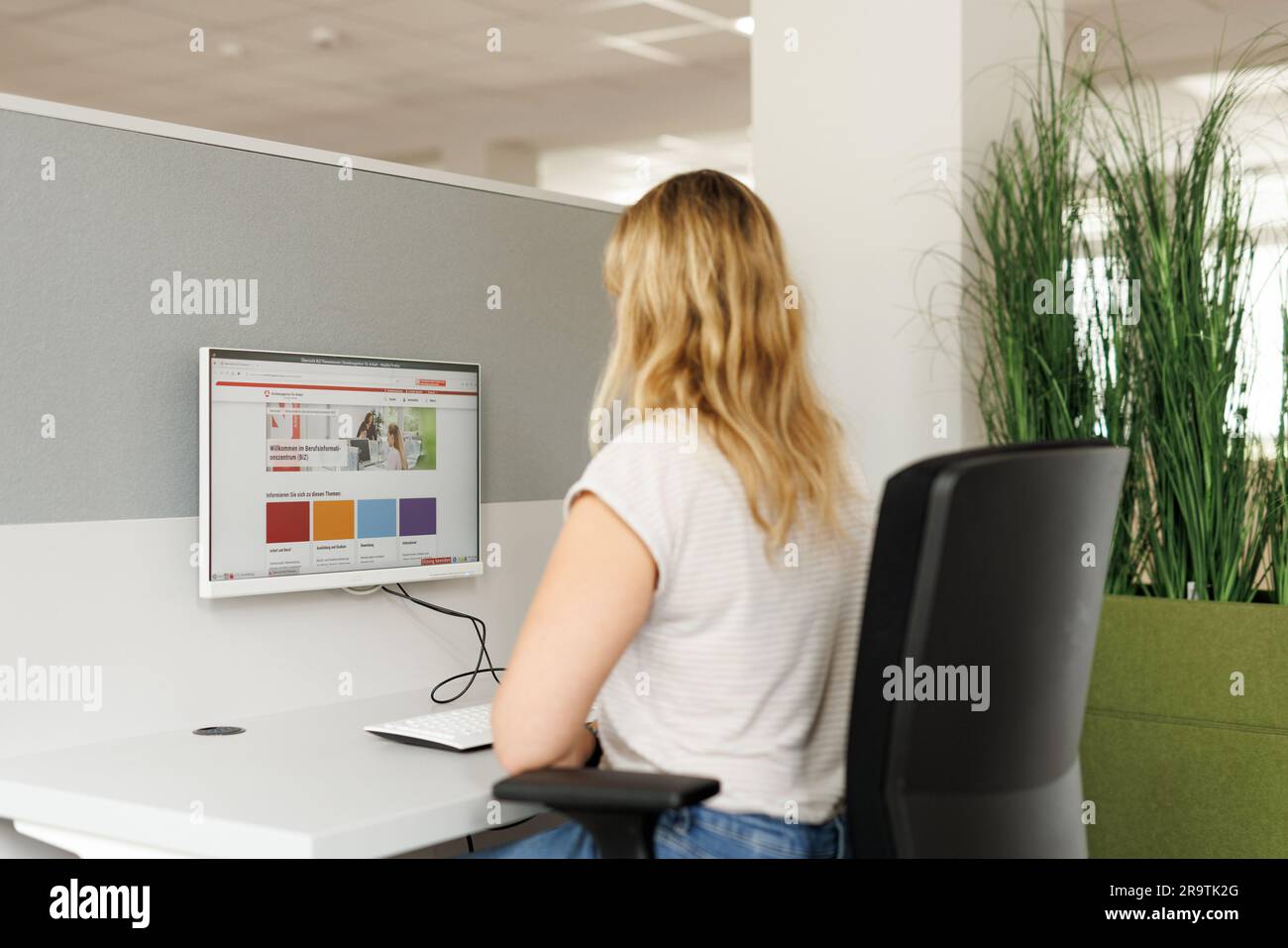 Berlin, Germany. 28th June, 2023. A woman sits at a computer workstation in the customer area at ...